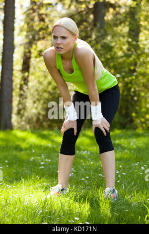 Tired attractive woman after jogging at the stadium Stock Photo - Alamy