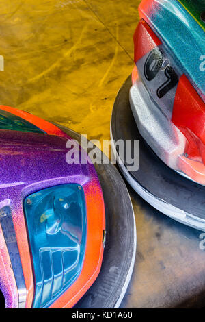 Close-up view of the front and rear parts of two colorful dodgem cars ...