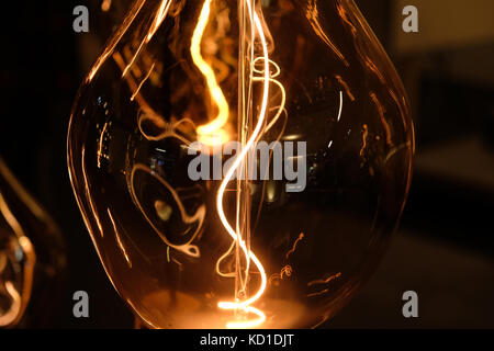 Close up of designer light installation, showing see through glass lamp ...