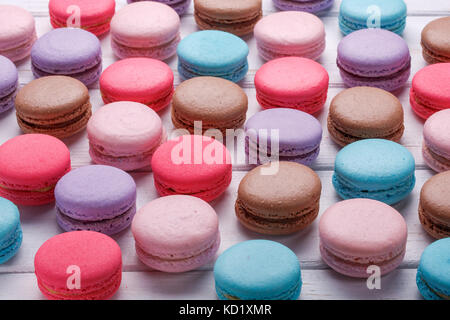 A lot of multicolored macarons (French macaroons) on the candy shop or ...