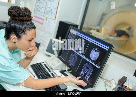 Radiologist with nurse control X-ray process from their office behind ...