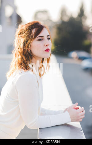 Woman looking out from balcony Stock Photo - Alamy