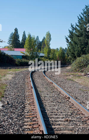 Train tracks through a rural neighborhood Stock Photo - Alamy