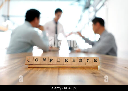 Conference word on wood table with Business team work discussion ...