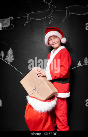 Santa Claus packing gifts in room decorated for Christmas Stock Photo ...