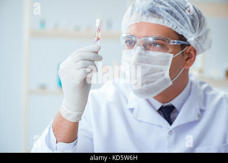 Chemist mixing perfumes in the lab Stock Photo - Alamy