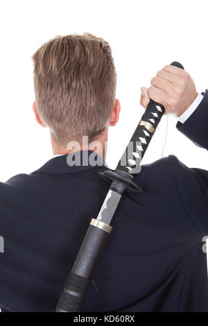 Close-up Of Businessman Removing Sword Over White Background Stock ...