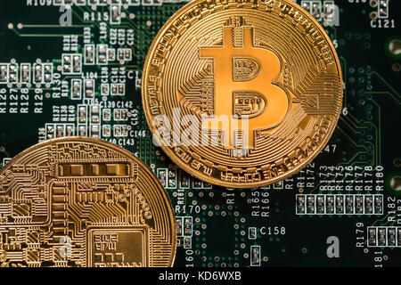 Golden Bitcoin coins on Motherboard, miner with circuit board, pool ...