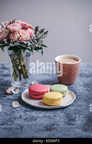 Sweet macaron dessert on the coffee beans background Stock Photo - Alamy