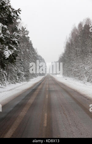 Road under the snow. Close-up of snow on the road. Impossibility of ...