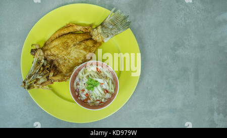 Deep fried fish with green mango salad Stock Photo - Alamy