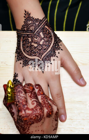 Top view art henna tattoo on woman hands. master artist drawing Arabic ...