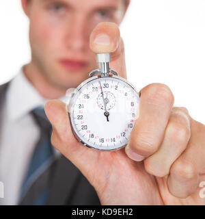 Male hand holding stopwatch on white background Stock Photo - Alamy