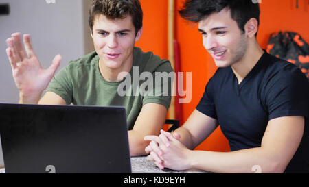 Young men with laptop video chatting on online date at home Stock Photo ...