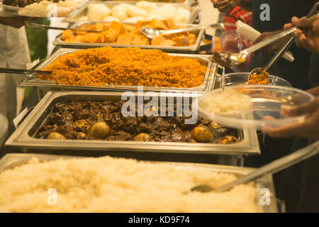 Nigerian food party: Jollof rice with fried chicken wings close-up on a ...