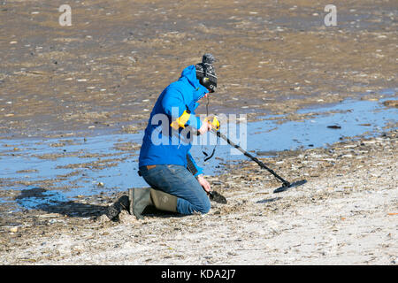 Metal detectorists scour the beach at Southport, UK looking for ...