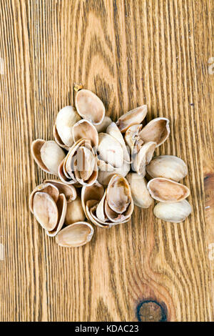 empty shells from salted pistachio nuts on the table, a large amount of ...