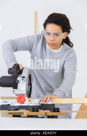 Female worker using circular saw Stock Photo - Alamy