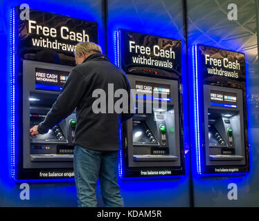 Cash machine / cashpoint / ATM facility, with a row of three machines ...