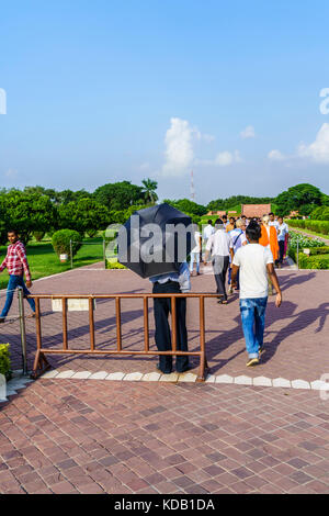 A security guard sheltering from the sun under an umbrella at the Lotus ...