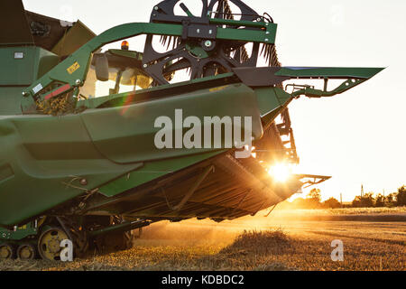 Cutting unit of a combine harvester at sunset Stock Photo - Alamy