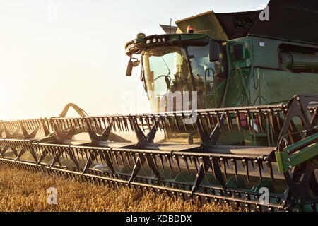 Cutting unit of a combine harvester at sunset Stock Photo - Alamy