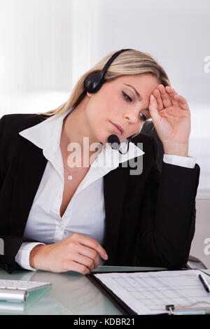 Overworked office receptionist Stock Photo - Alamy