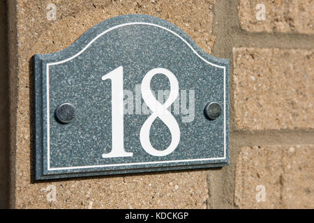 House number "18" attached to a wall Stock Photo - Alamy