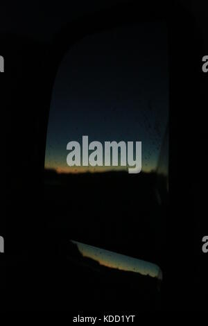 Sunset in the rearview mirror Stock Photo - Alamy