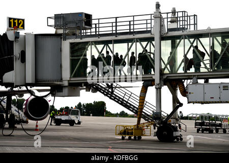 Passengers boarding on airplane through a jetway Stock Photo - Alamy