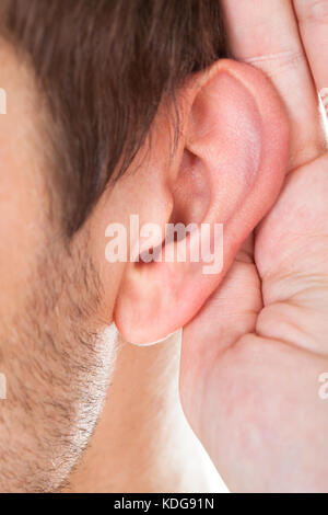 Human ear and hand close-up isolated on white Stock Photo - Alamy