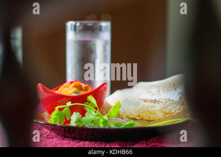 Indian Gee rice with complete curry meal served on a tray in a ...