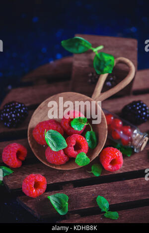 Fresh ripe raspberries with mint leaves as background Stock Photo - Alamy