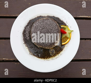 Sweet bun with poppy seeds and sugar icing isolated on a white ...