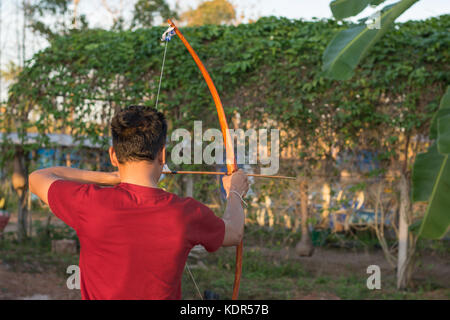 A young archer takes aim at the target Stock Photo - Alamy