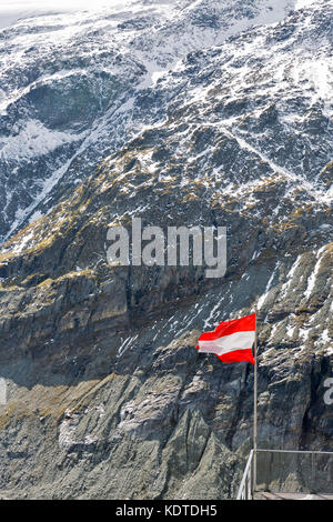 Austrian flag in Grossglockner National Park, snowcapped alps at ...