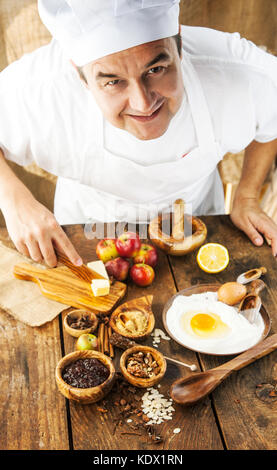 Baking concept background. Baker with ingredients for pastry desserts ...