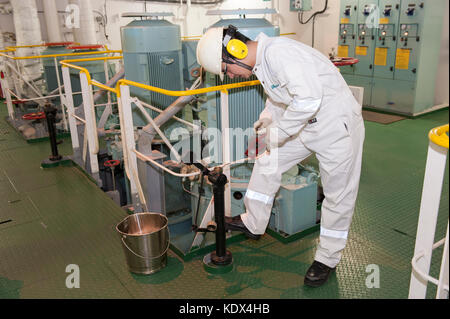 Marine engineer in ship's engine room Stock Photo - Alamy