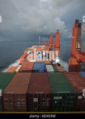 View of a merchant ship from the bridge wings of another ship at sea ...
