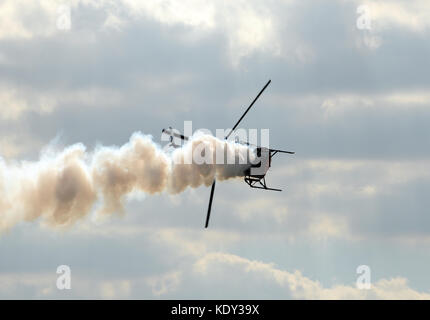 Small helicopter landing with engine fire Stock Photo - Alamy