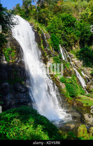 Close-stream waterfall which flows swiftly through severe cliff rocks ...