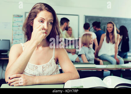 Sad lonely student sits at her desk in the classroom Stock Photo - Alamy