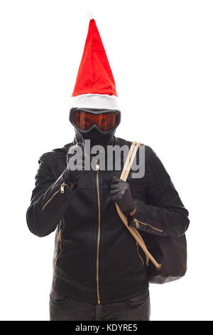 Masked burglar with santa claus cap holding his sack, posing on ...