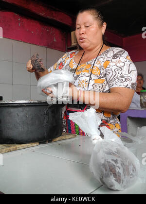 Norma Romero Vazquez from "Las Patronas" fills lentils and beans into ...