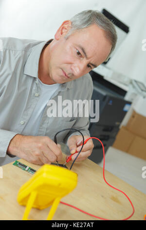 Technician using multimeter Stock Photo - Alamy