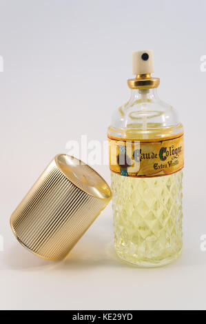 Bottle of cologne water old vintage with its golden cap on a white ...