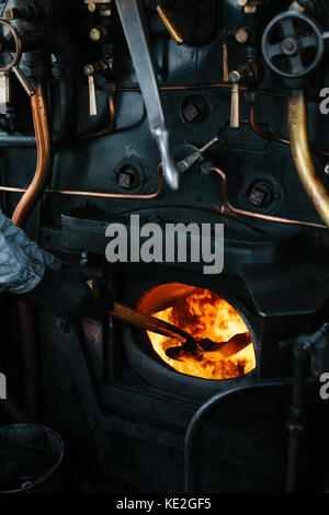 Stoking a fire of a steam locomotive Stock Photo - Alamy