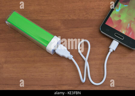 charging smartphone with power bank, high angle view Stock Photo - Alamy