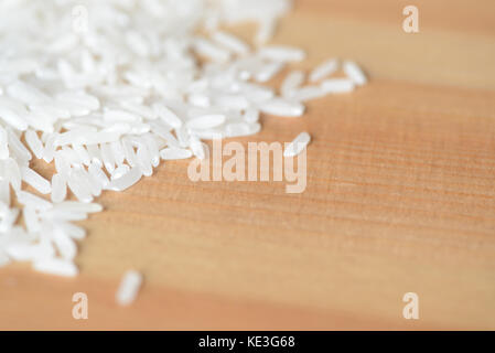 Scattered rice grains on the wooden surface Stock Photo - Alamy