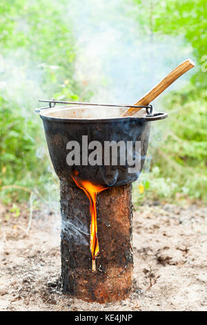 Swedish or finnish log candle. Fire burning from inside the wooden log ...